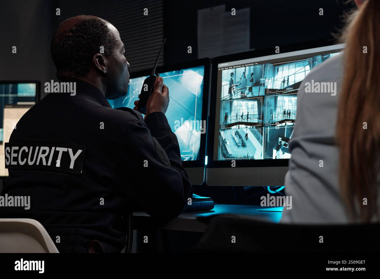 Mature African American man talking in radio transceiver and looking at ...