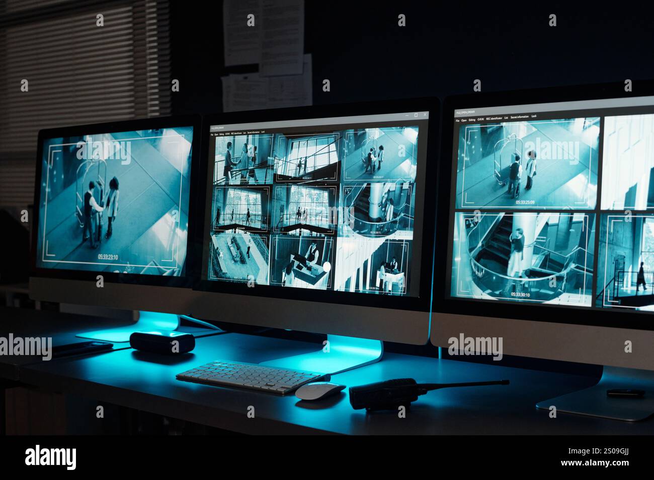 Screens of desktop computers with cctv videos on screens standing in ...