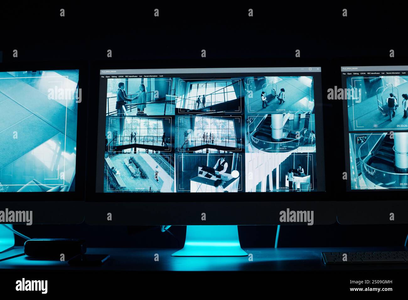 Screens of several desktop computer monitors with cctv video records by ...