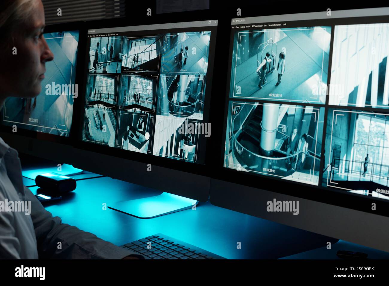 Focus on desktop computer monitors with cctv video system on screens ...