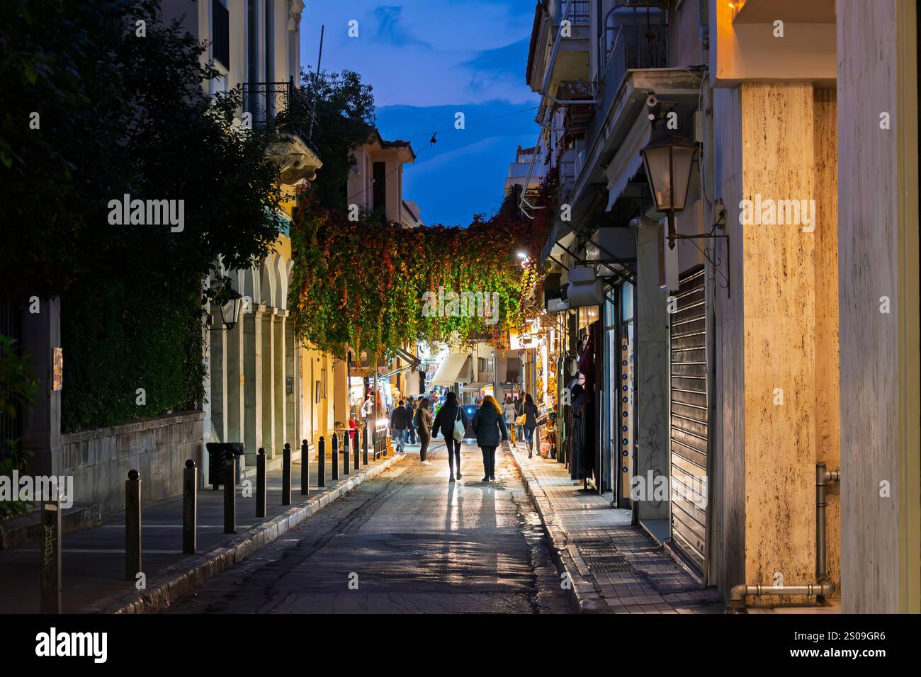 Late night on an illuminated narrow pedestrian street of souvenir ...