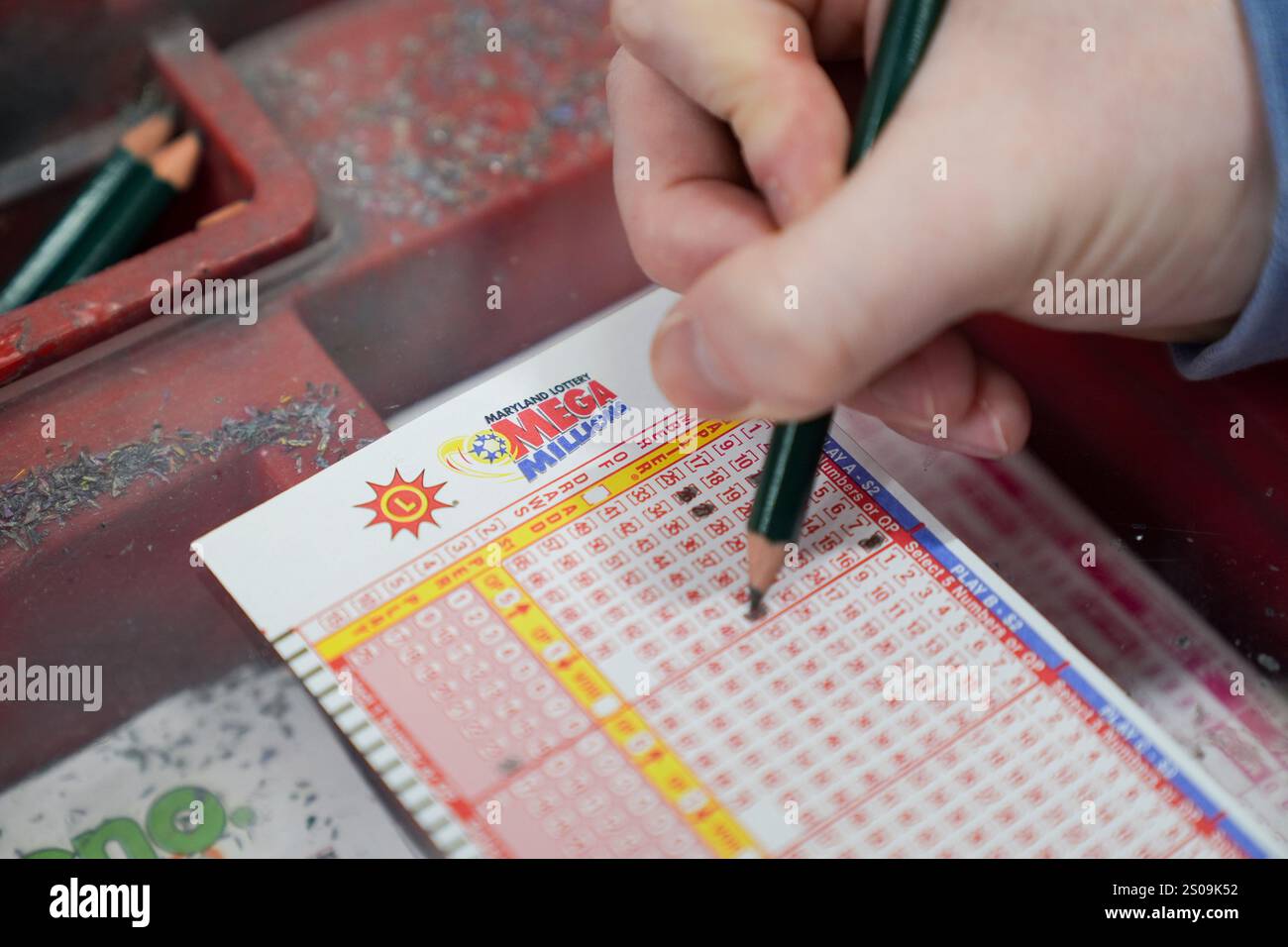 A person fills out a Mega Millions play slip ahead of Friday's Mega ...