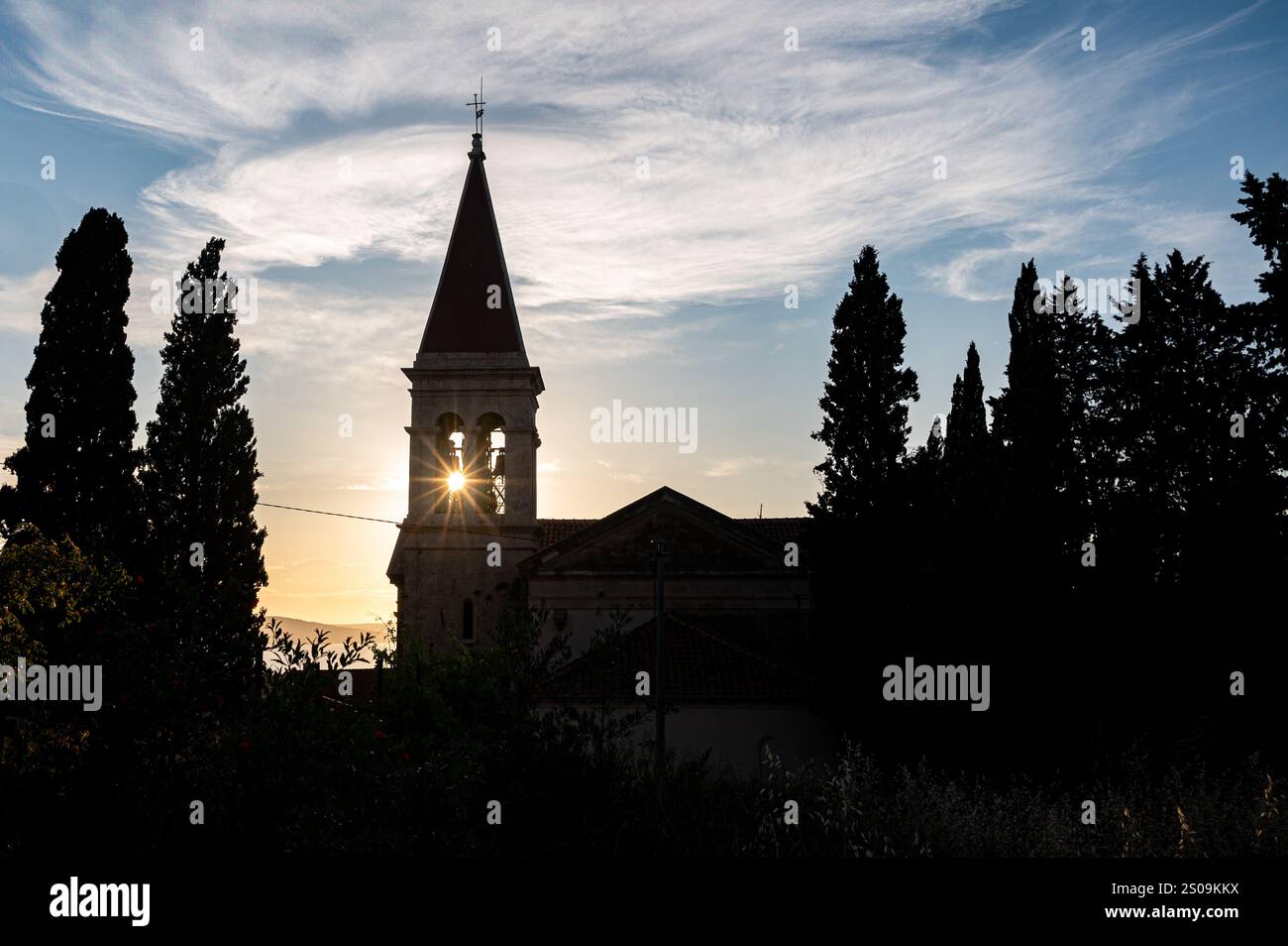Sunset through the bell tower of church of St George, mid way between ...