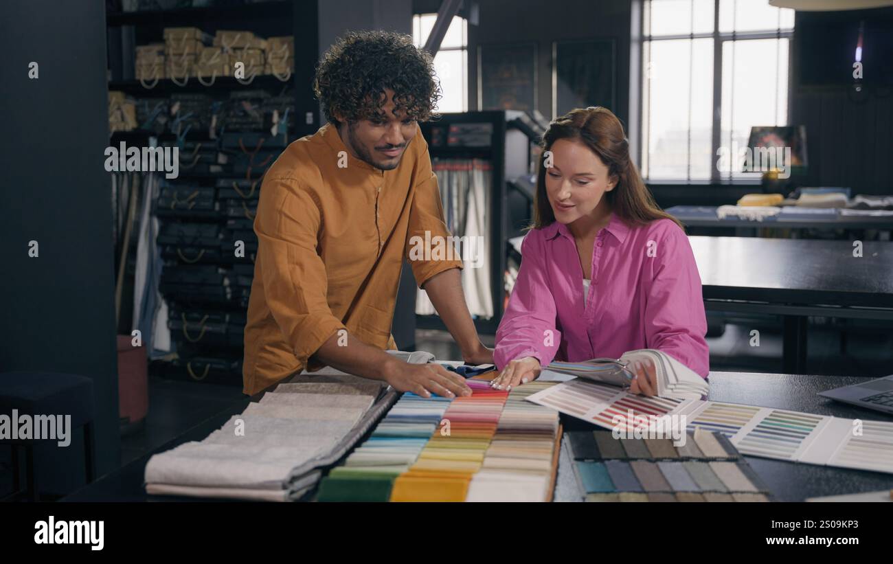 Diverse fashion designers Arabian man Caucasian woman couple customers ...