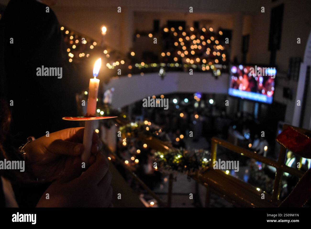 Bandung, Indonesia. 24th Dec, 2024. (12/24/2024) A Indonesian Christians hold a candle during a ...