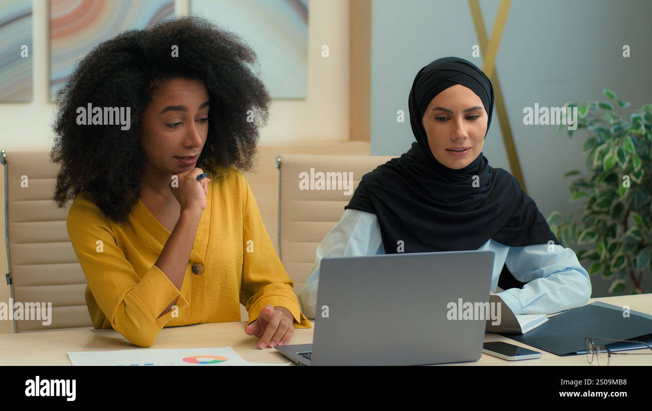 Multiethnic women girls working with laptop computer at office diverse ...