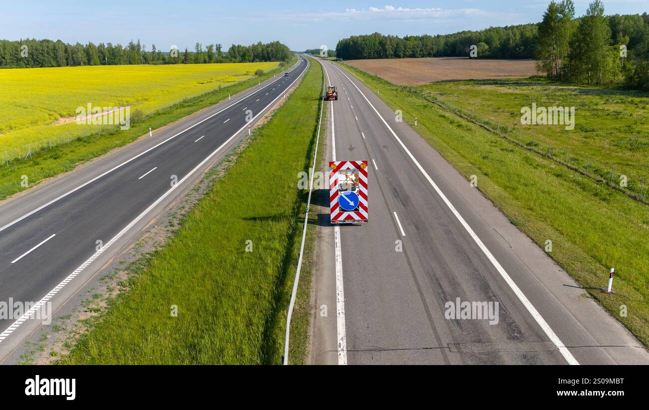 Aerial view of a rural highway with a maintenance vehicle and warning ...
