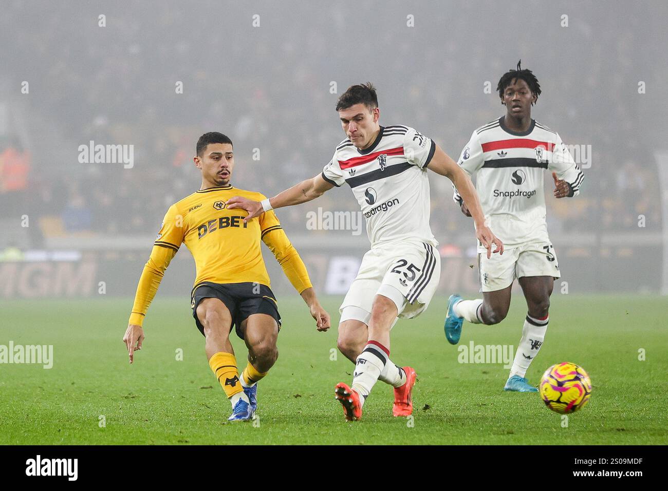 #7, Andr of Wolves plays it forward in front of #25, Manuel Ugarte of ...