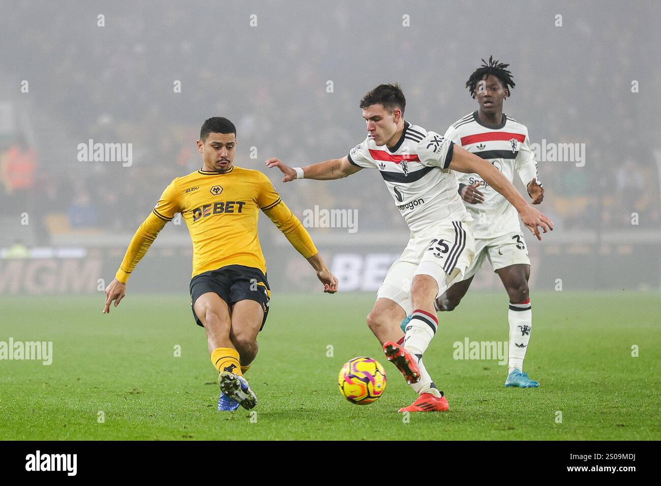 #7, Andr of Wolves plays it forward in front of #25, Manuel Ugarte of ...