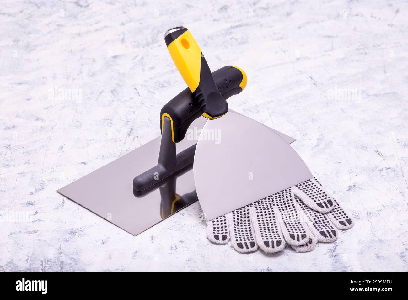 A set of hand tools for plastering and leveling the walls on white-grey ...