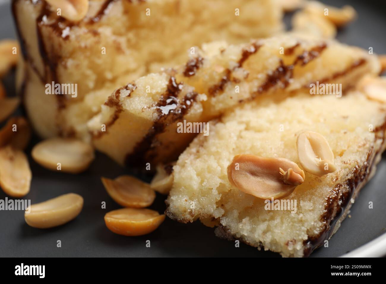 Delicious sweet semolina halva with peanuts on plate, closeup Stock ...