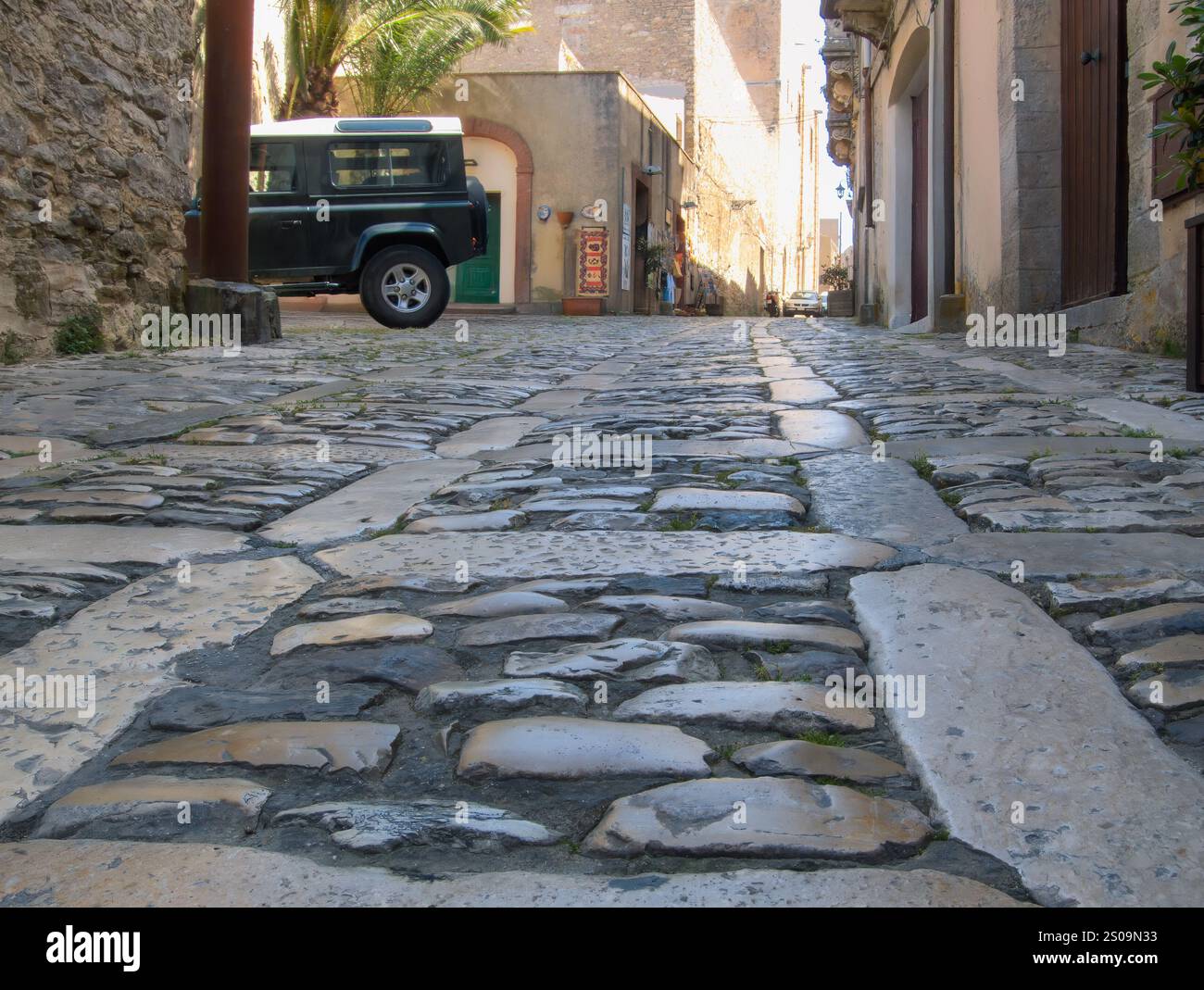 Ancient cobblestone street in Erice with historic stone walls . Sicily ...