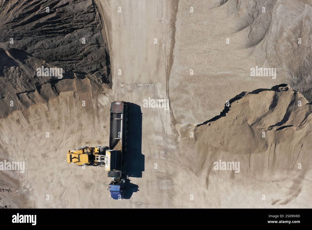Aerial view construction front loaders at aggregate storage facility ...