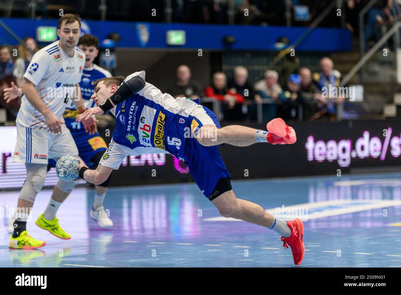 Eisenach, Deutschland. 26th Dec, 2024. Simone Mengon (ThSV Eisenach, #15), Andreas Magaard ...