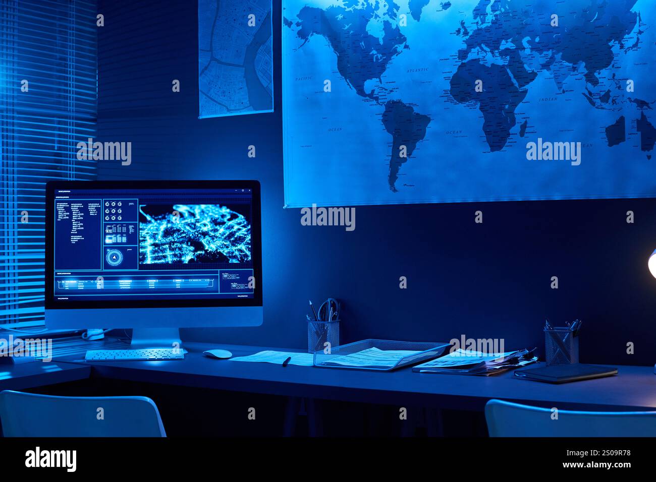 Computer monitor with location data on screen standing on desk by wall ...