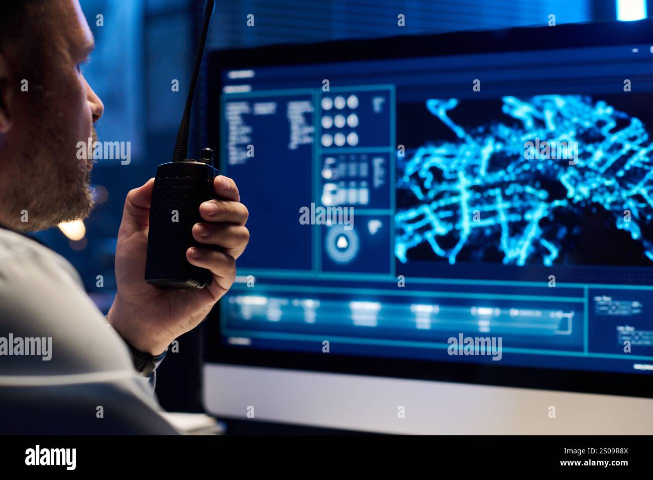 Confident mature male operator of military command center speaking in ...