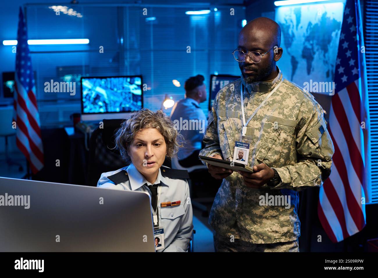 Young African American male officer and his mature female colleague ...