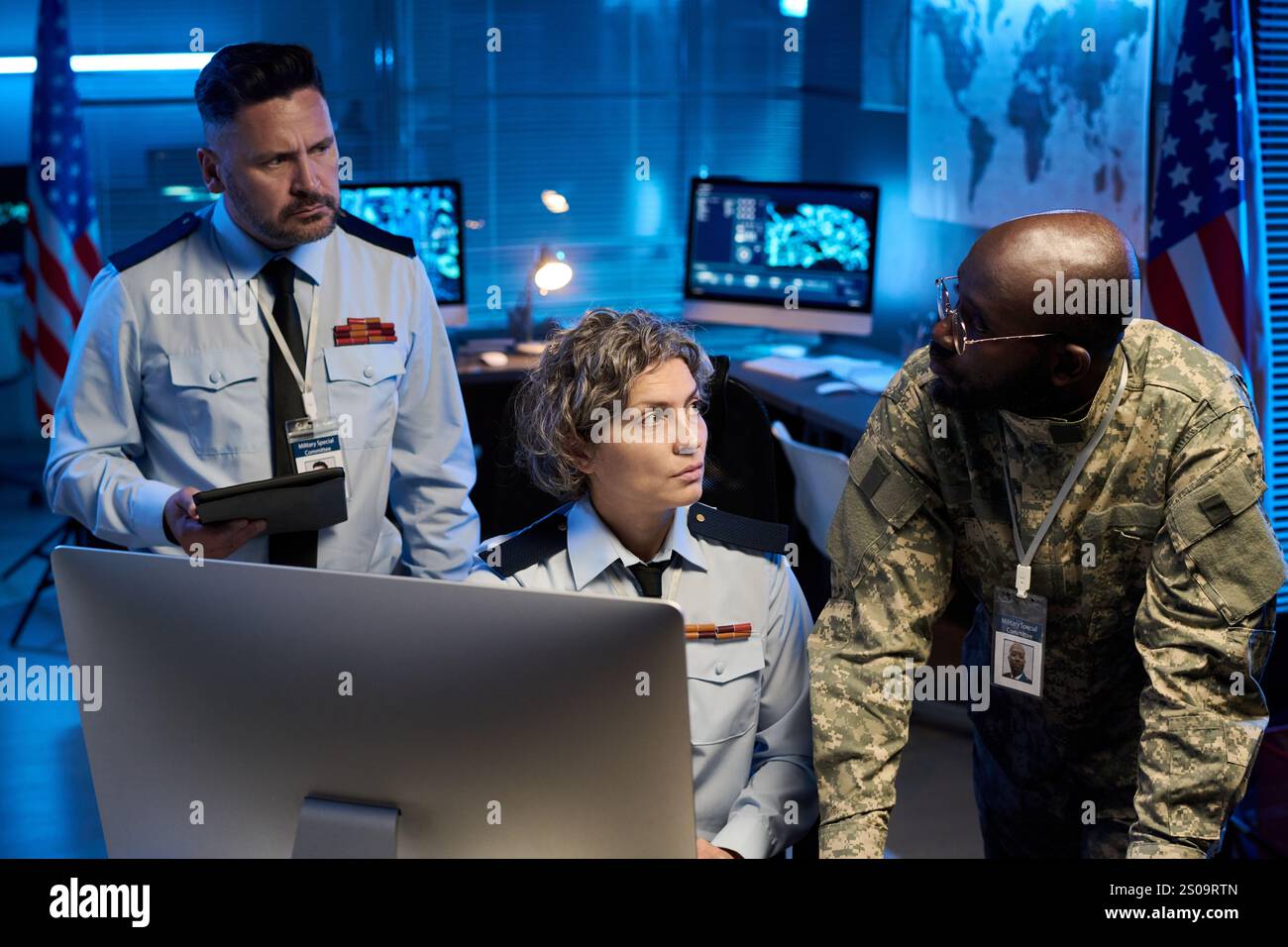 Serious mature woman in uniform looking at young African American male ...