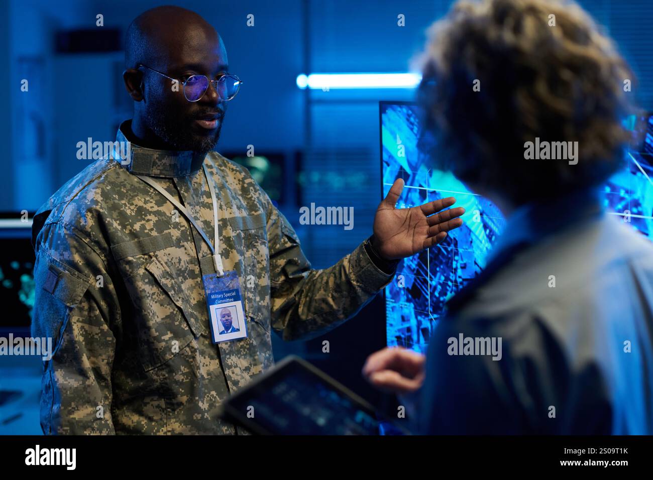Confident African American man in camouflage uniform pointing at ...