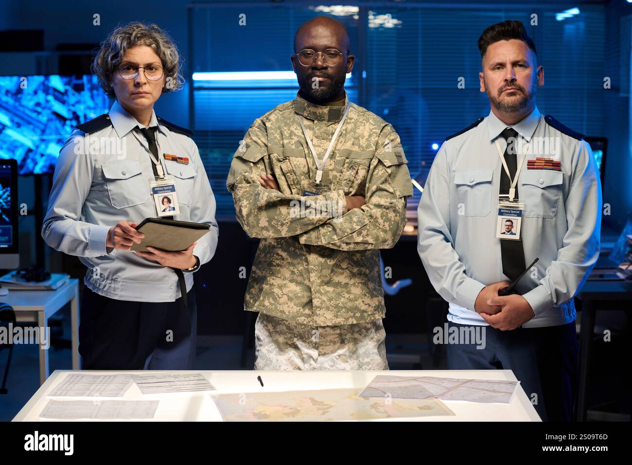 Two mature officers in blue uniform and their young African American ...