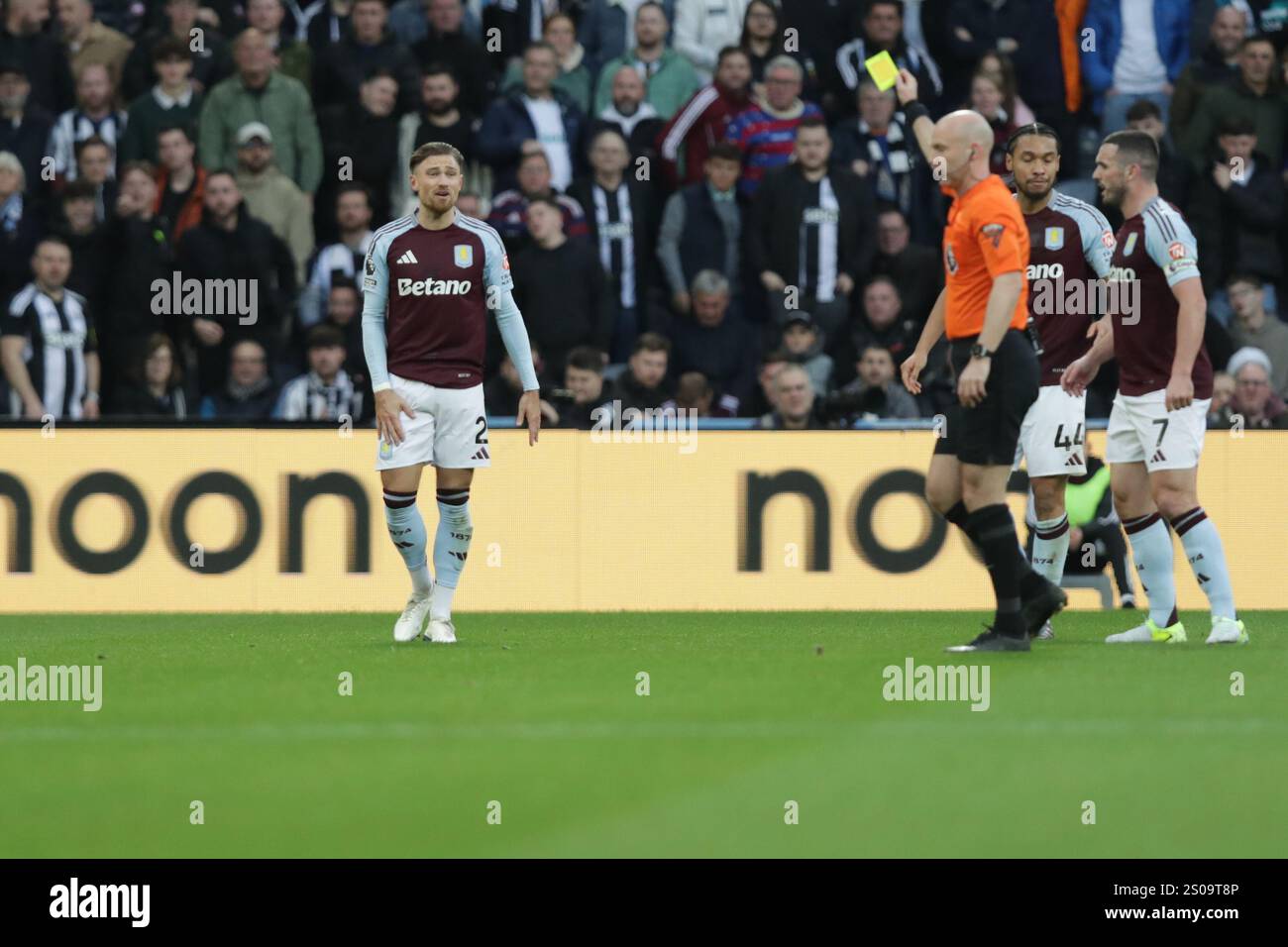 Matty Cash of Aston Villa receives a yellow card for fouling Anthony ...