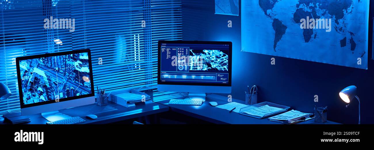 Header of desks with computer monitors with location data on screens ...