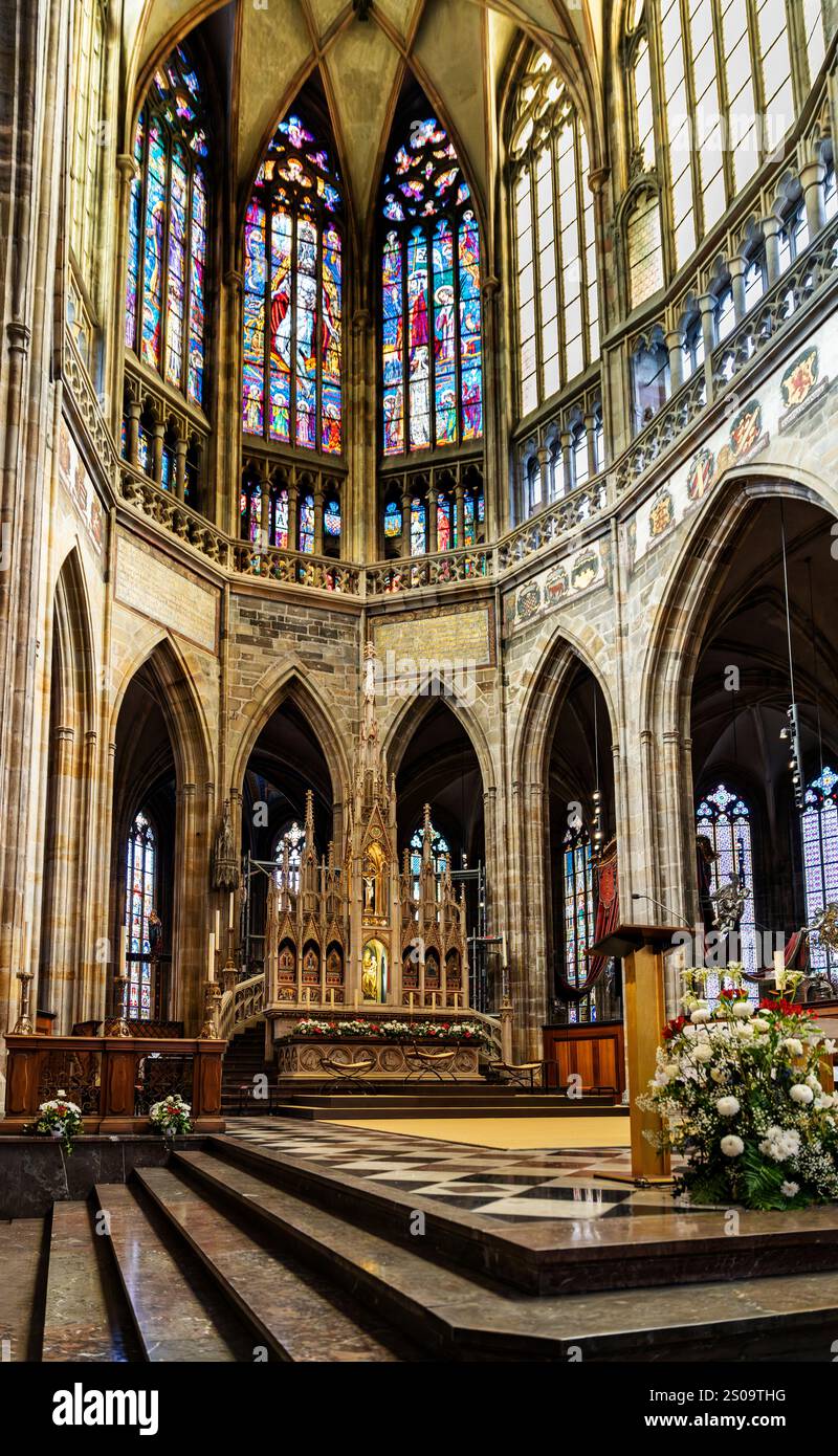 Altar and apse of St Vitus Cathedral with colorful stained glass ...