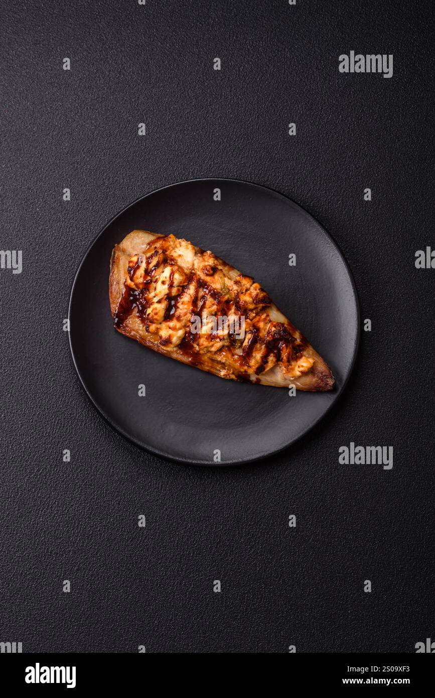 Grilled mackerel fillets with cheese, salt, spices and herbs on dark ...