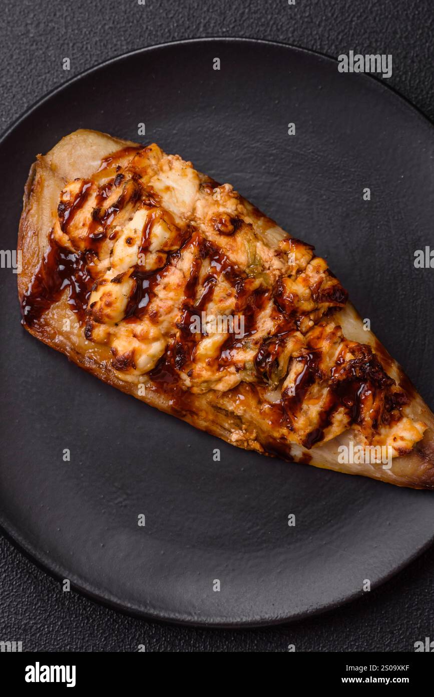Grilled mackerel fillets with cheese, salt, spices and herbs on dark ...