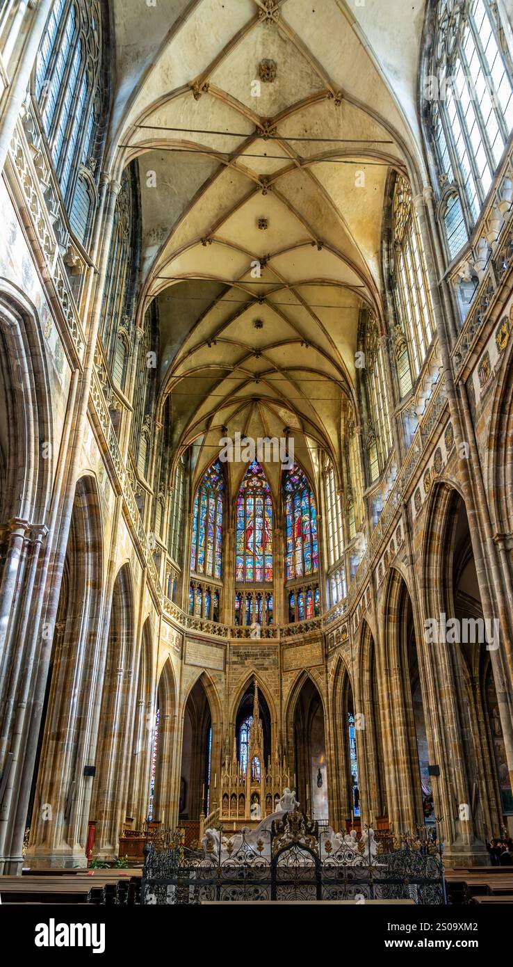 Main nave and apse of St Vitus Cathedral with colorful stained glass ...