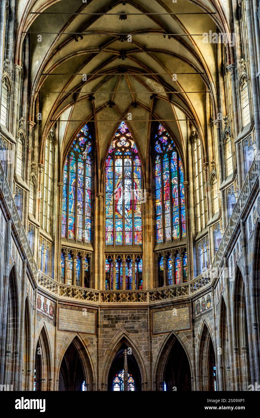Main nave and apse of St Vitus Cathedral with colorful stained glass ...