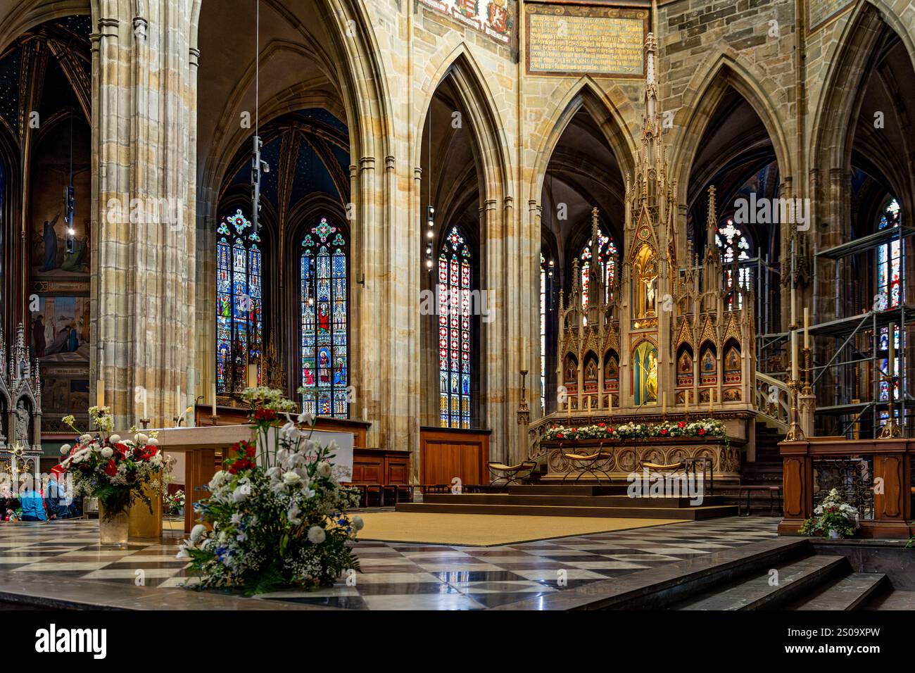 Altar and ambulatory of St Vitus Cathedral with colorful stained glass ...