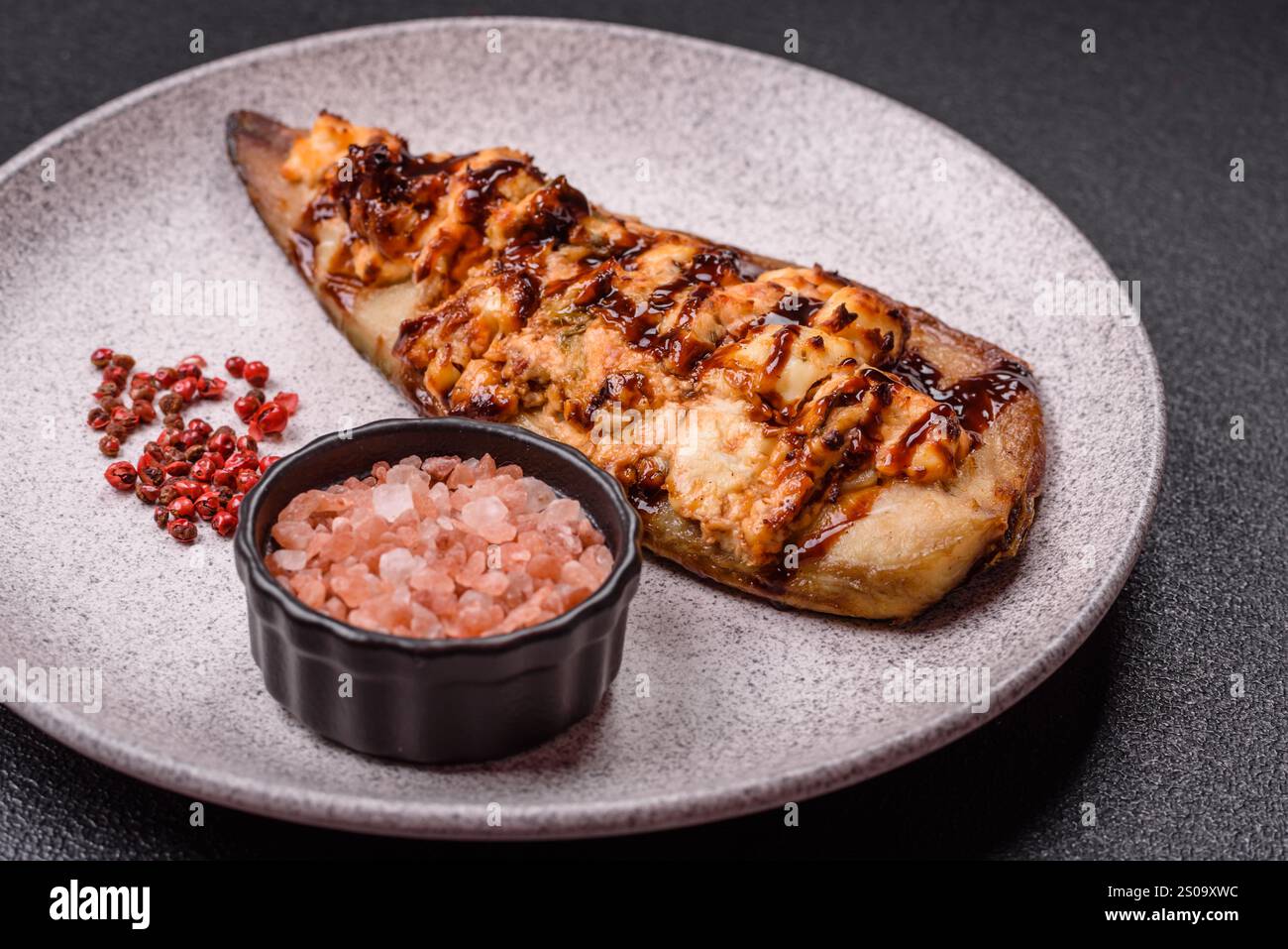 Grilled mackerel fillets with cheese, salt, spices and herbs on dark ...