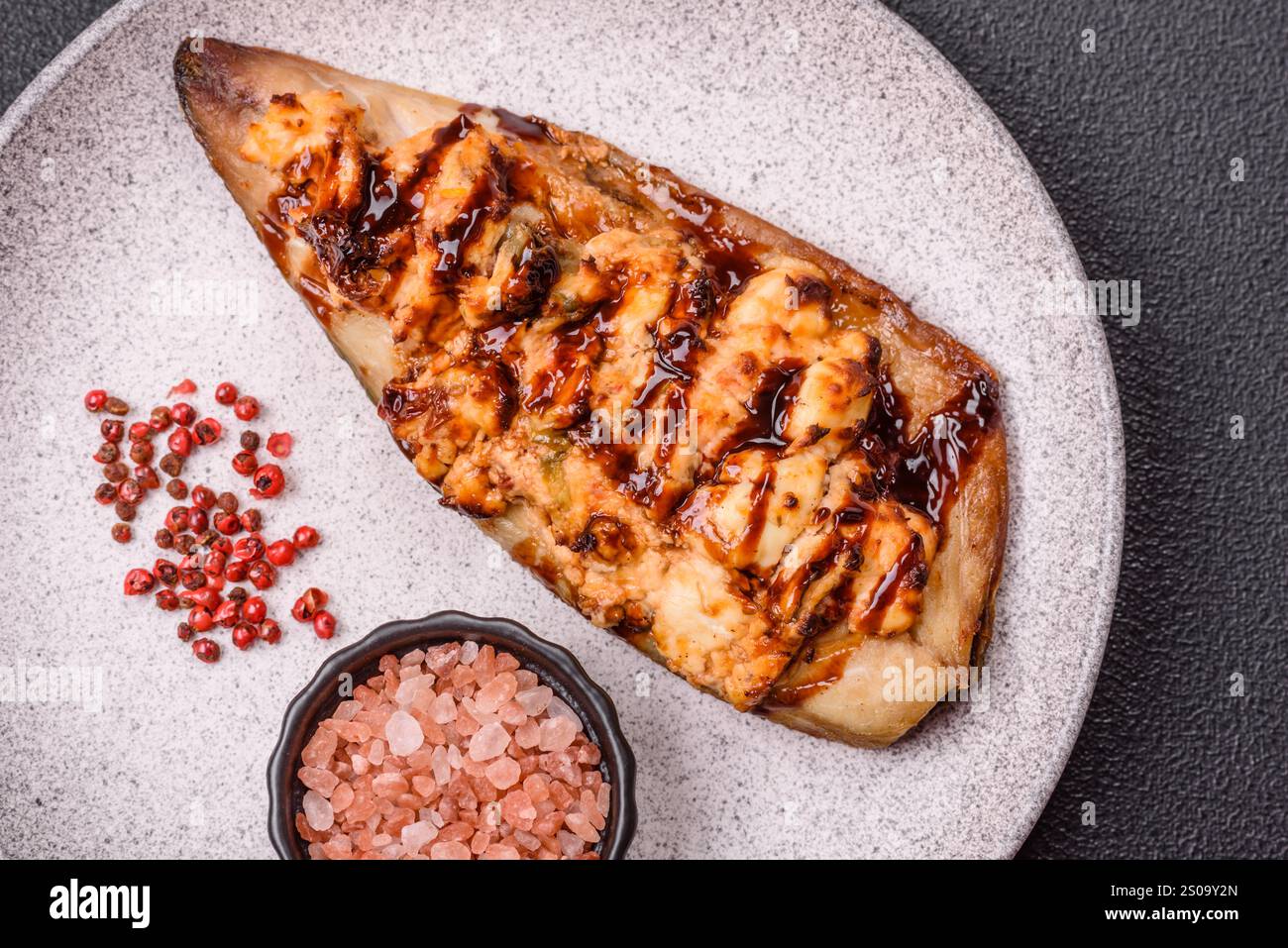 Grilled mackerel fillets with cheese, salt, spices and herbs on dark ...