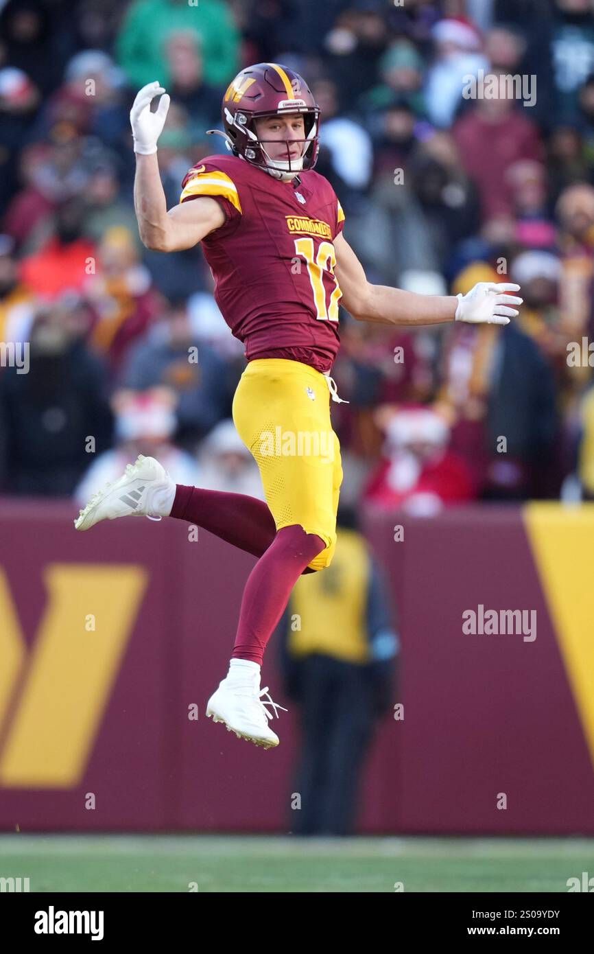 Washington Commanders wide receiver Luke McCaffrey (12) leaps for an ...