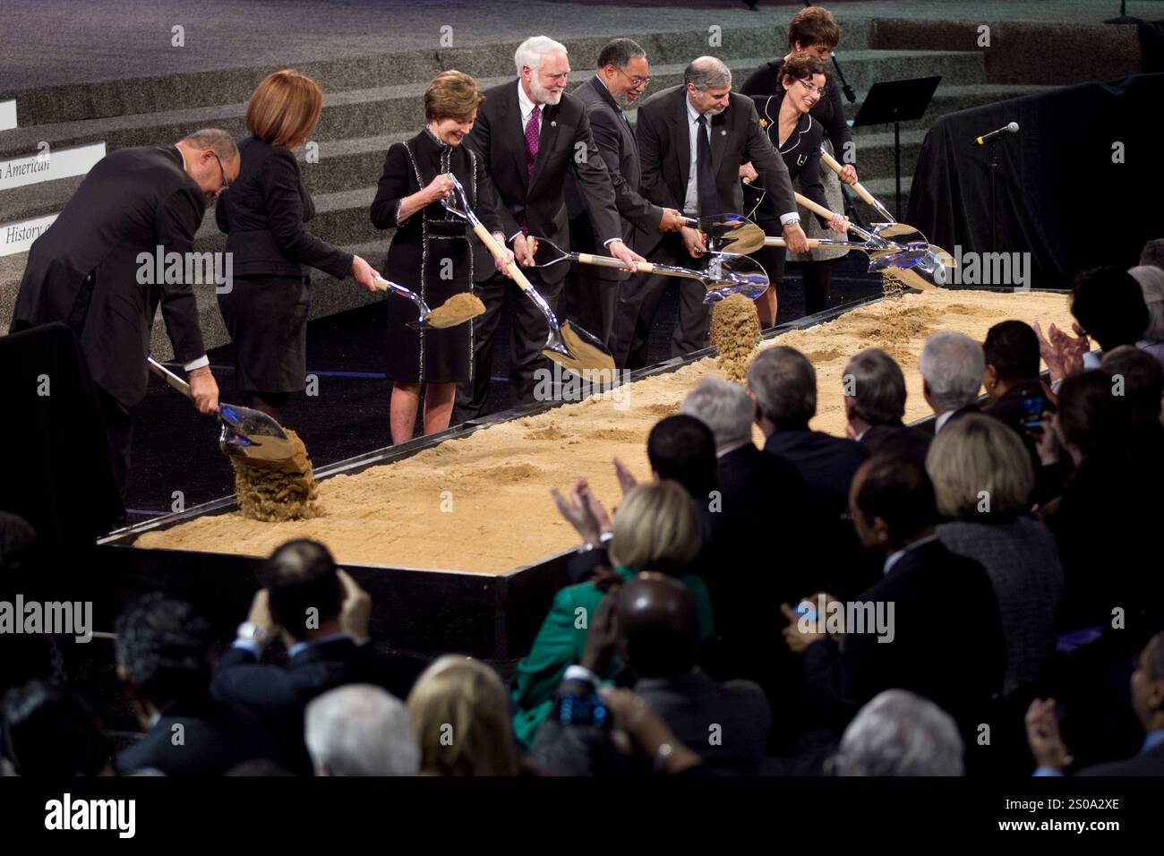 Participants break ground at the groundbreaking of the Smithsonian ...