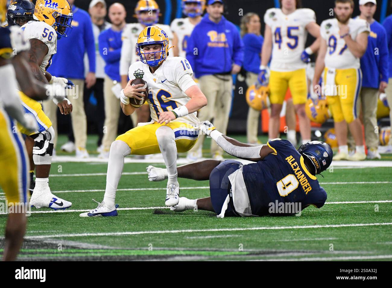 Toledo defensive tackle Darius Alexander, bottom right, sacks ...