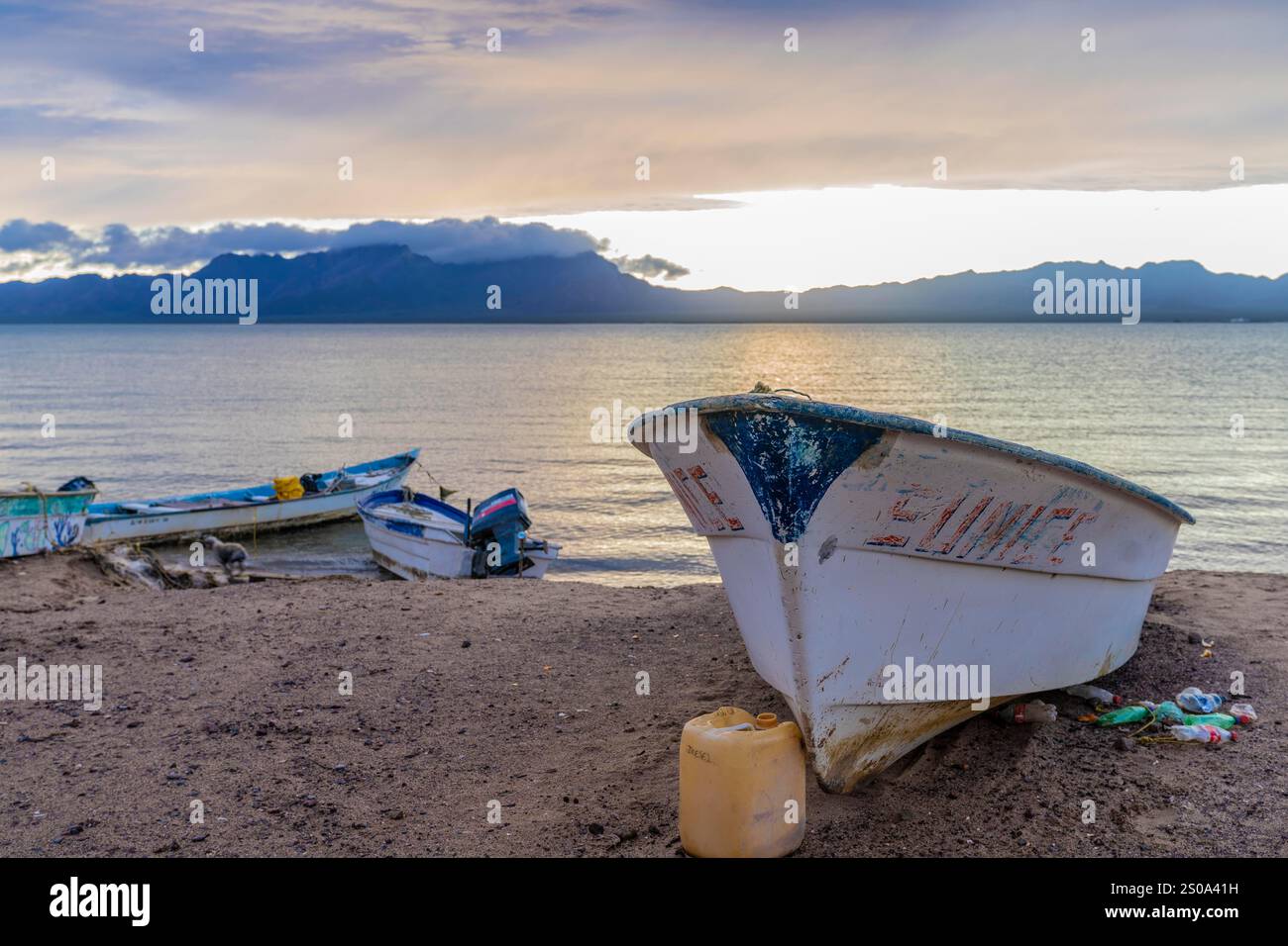 fishing boats on the shore of the beach at sunset and last night ...
