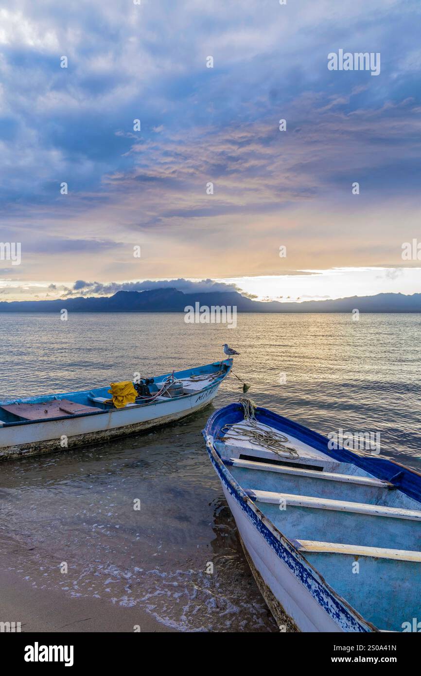 fishing boats on the shore of the beach at sunset and last night ...