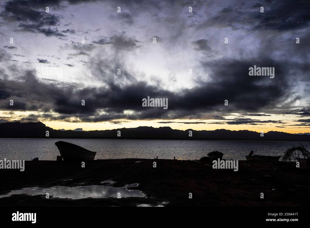 fishing boats on the shore of the beach at sunset and last night ...