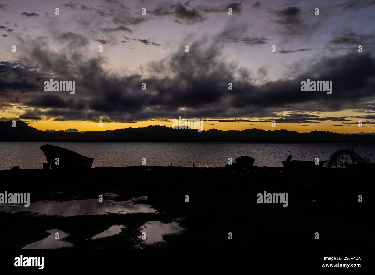 fishing boats on the shore of the beach at sunset and last night ...
