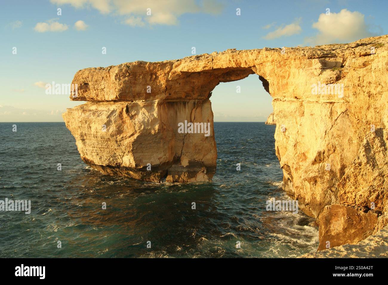 A natural stone arch called Azure Window on the Gozo island, Malta in a ...