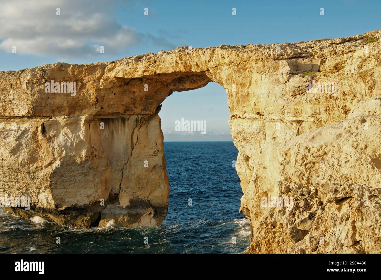 A natural stone arch called Azure Window on the Gozo island, Malta in a ...