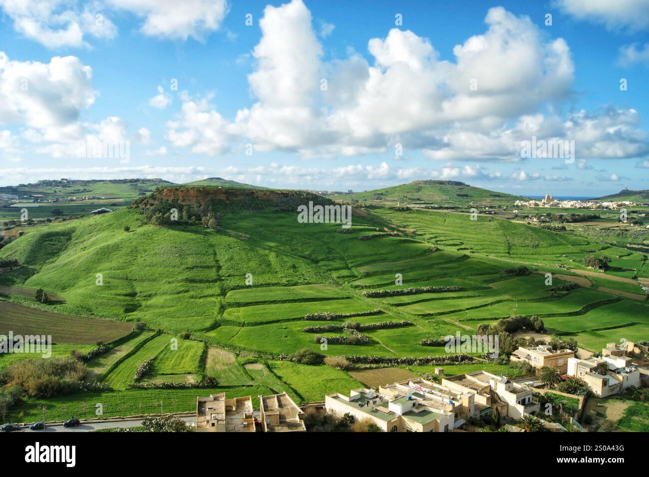 A picturesque view of a green hills with fields from the observation ...