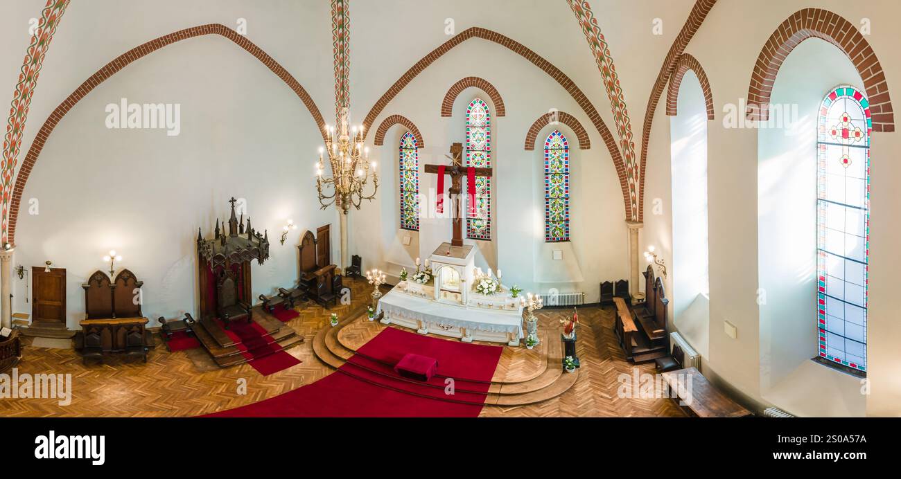 The church interior features a decorated altar with white flowers, a ...