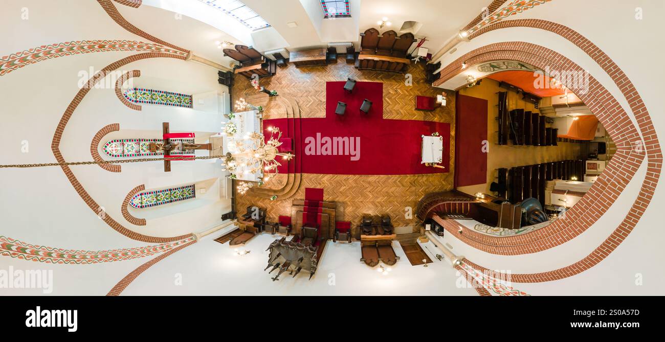 The image captures an aerial view of a church interior, featuring a red ...