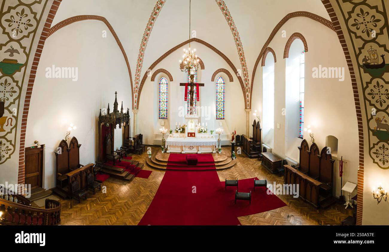 The church interior features a designed altar, arched ceilings, stained ...