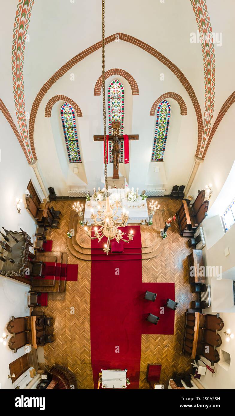 The image captures an aerial view of a church interior, highlighting a ...