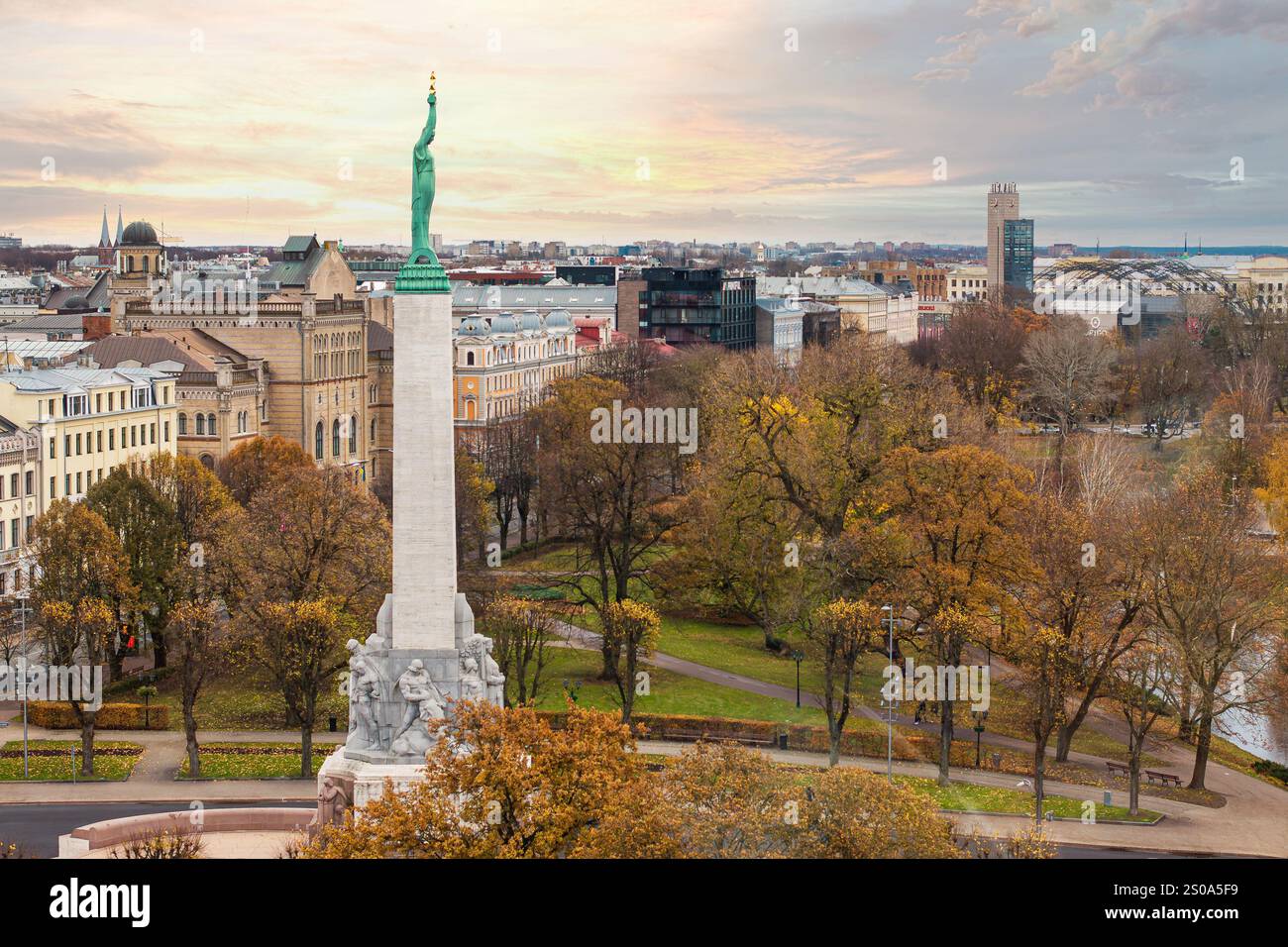 The Freedom Monument in Riga, Latvia, is surrounded by autumn trees ...