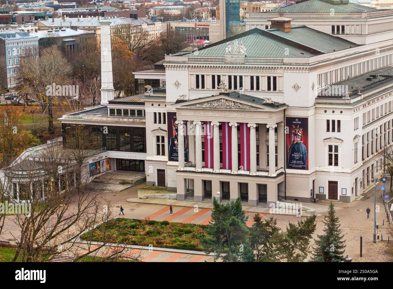 The Latvian National Opera in Riga features neoclassical architecture with columns and banners ...